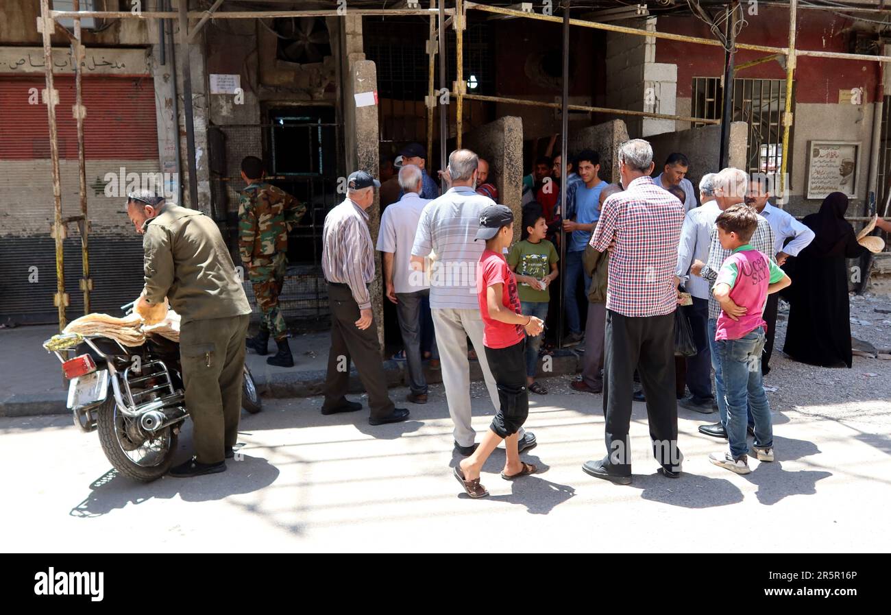 People queue at a bakery in downtown Damascus, Syria, June 4 2023 ...
