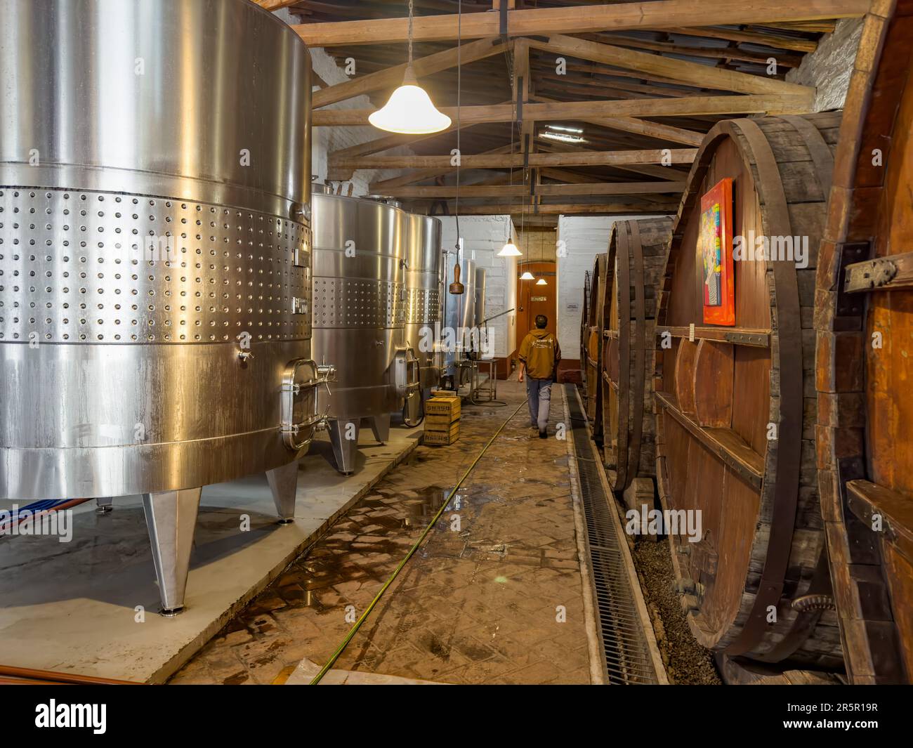 Modern stainless steel fermentation vats an large oaken barrels for ...