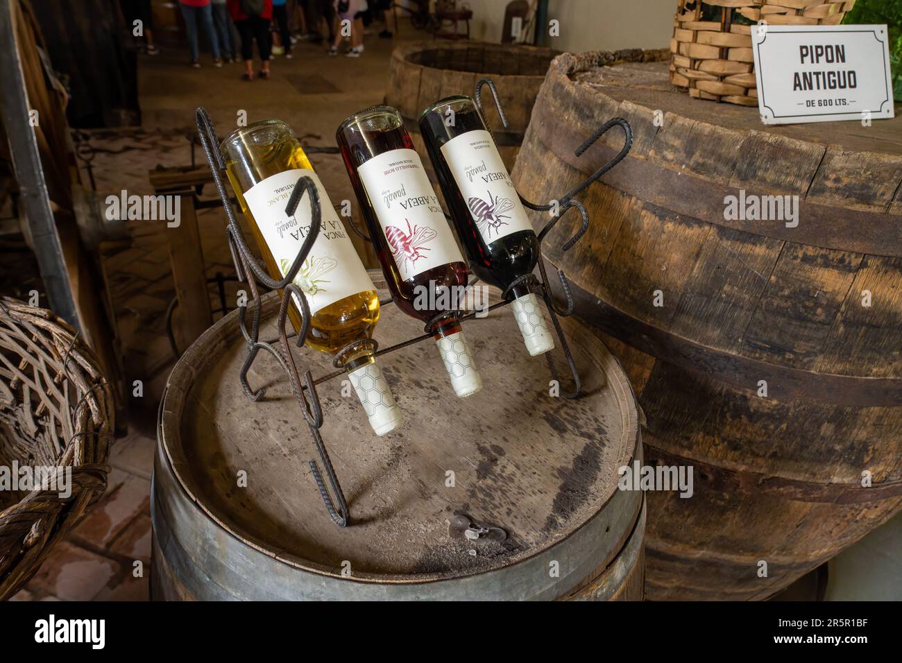 Wines on display on an old oaken wine cask at La Abeja Winery, San ...