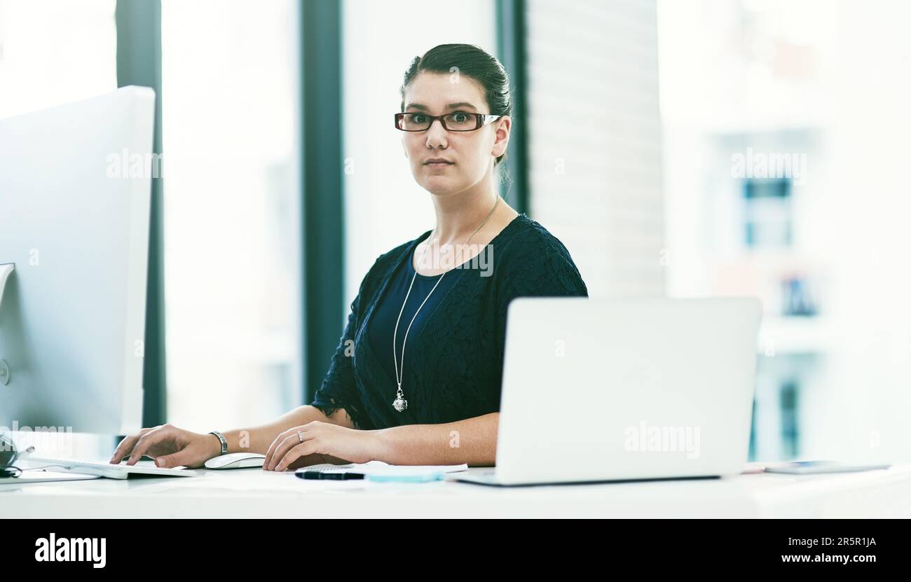 Im in charge here. Portrait of a young businesswoman working at her ...