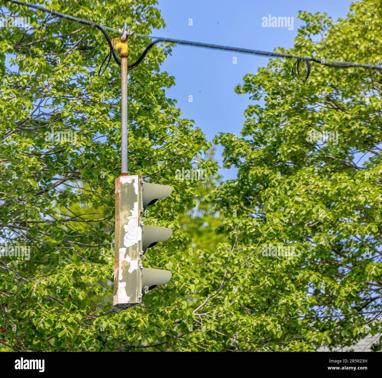profile of an old traffic signal hanging from a line in Bridgehampton ...