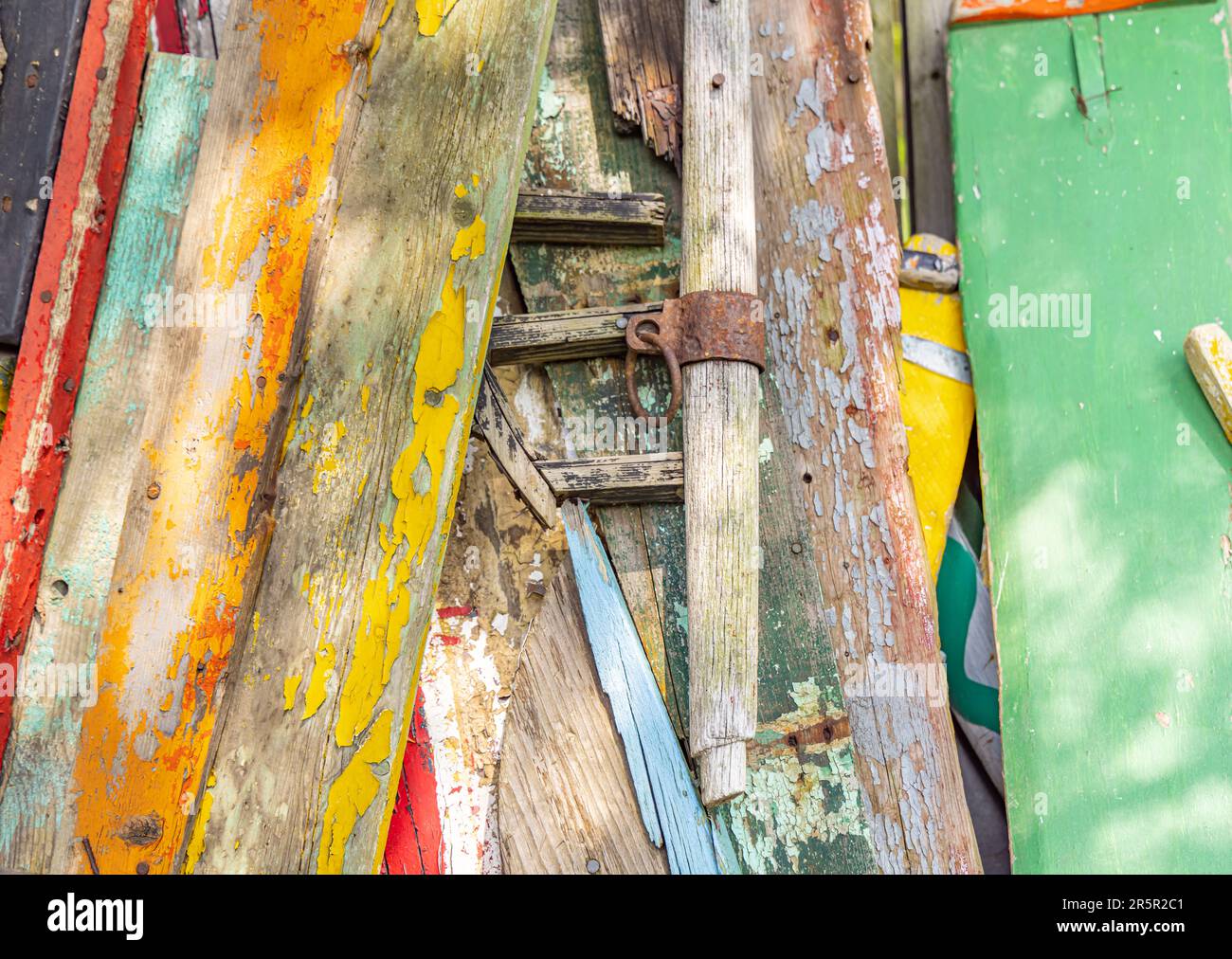 random colorful old wooden objects stacked up Stock Photo - Alamy