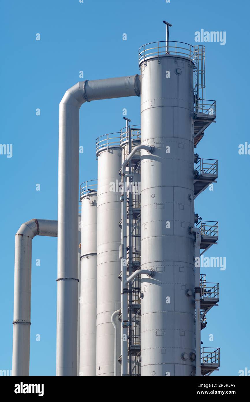 An industrial building with a cylindrical tower featuring a series of ...