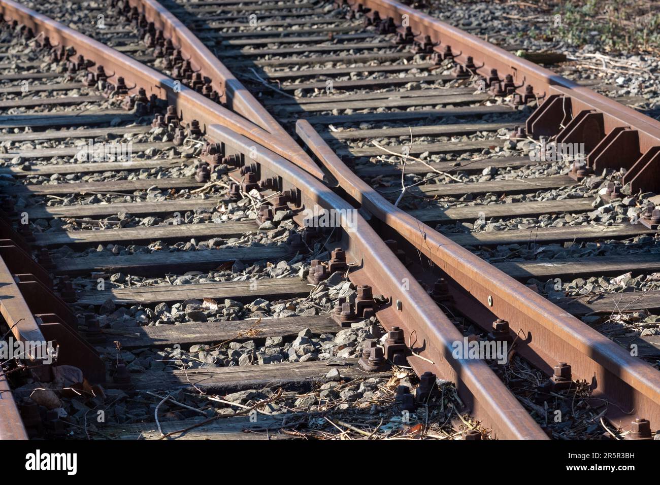 A close-up of two railway tracks side-by-side on a graveled stretch of ...