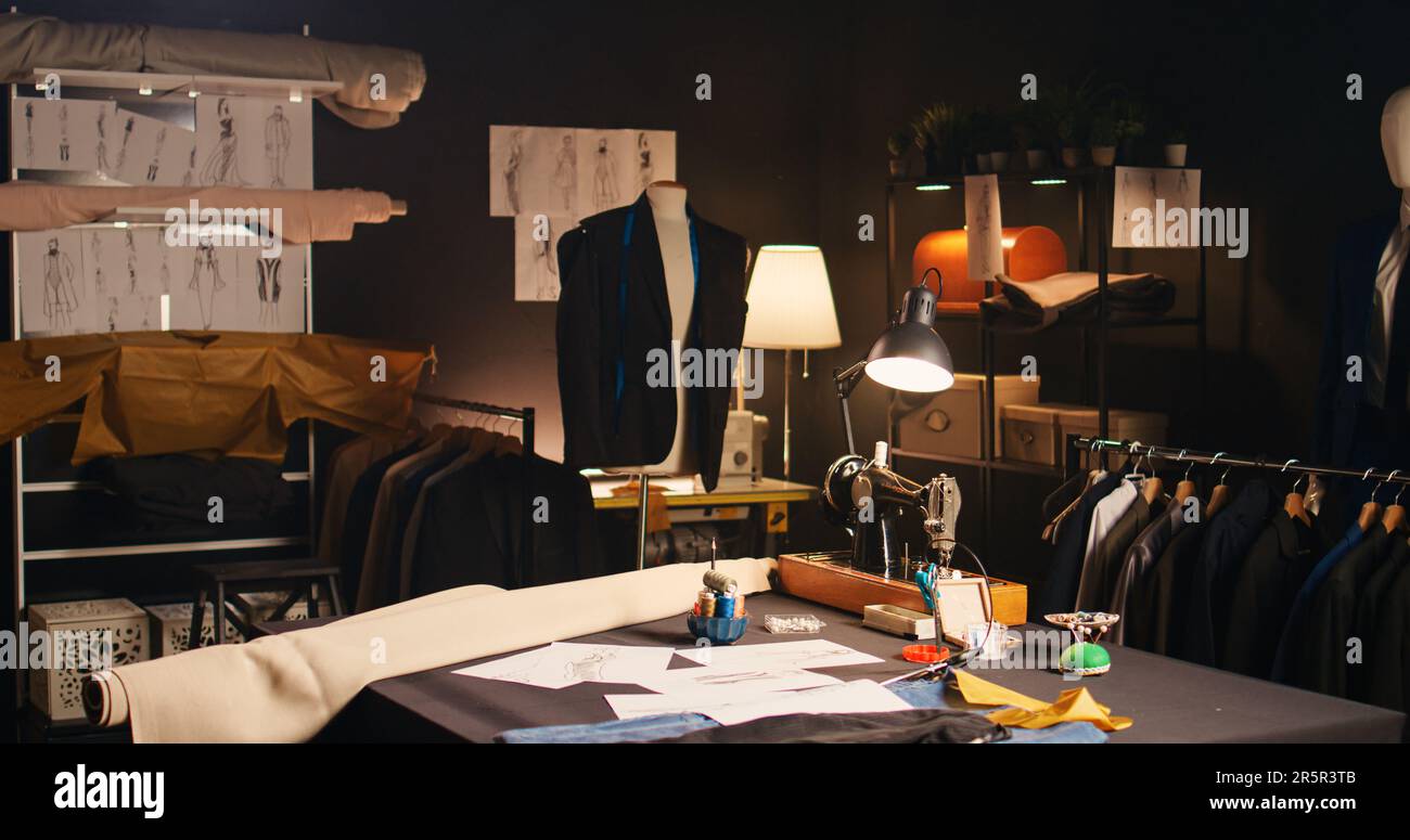 Fashion atelier with clothes sketches and tools, sewing machines and ...