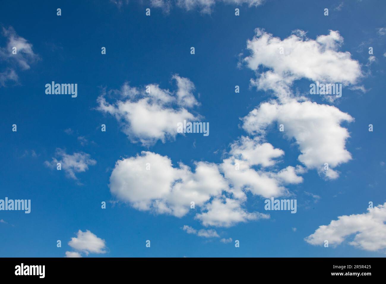 puffy small clouds at a blue sky gives a harmonic background in nature ...