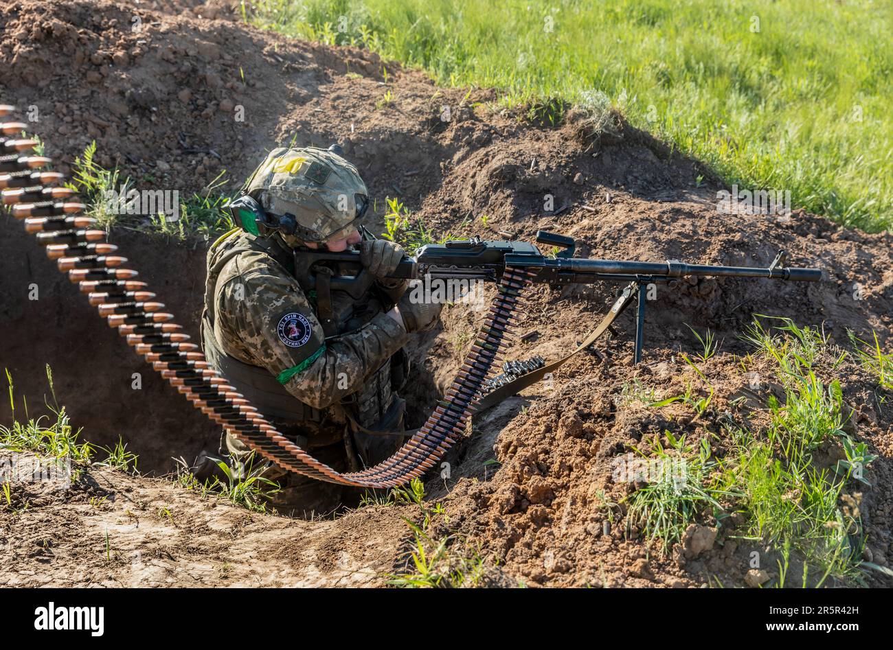 A Ukrainian Armed Forces soldier fires an automatic weapon during ...