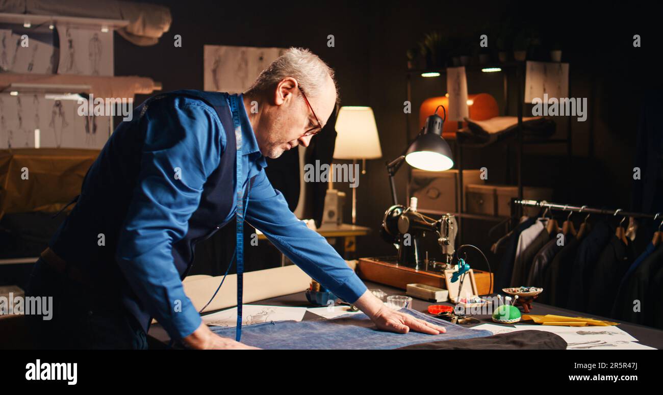Couturier using material for handcraft, preparing fabric in atelier to ...