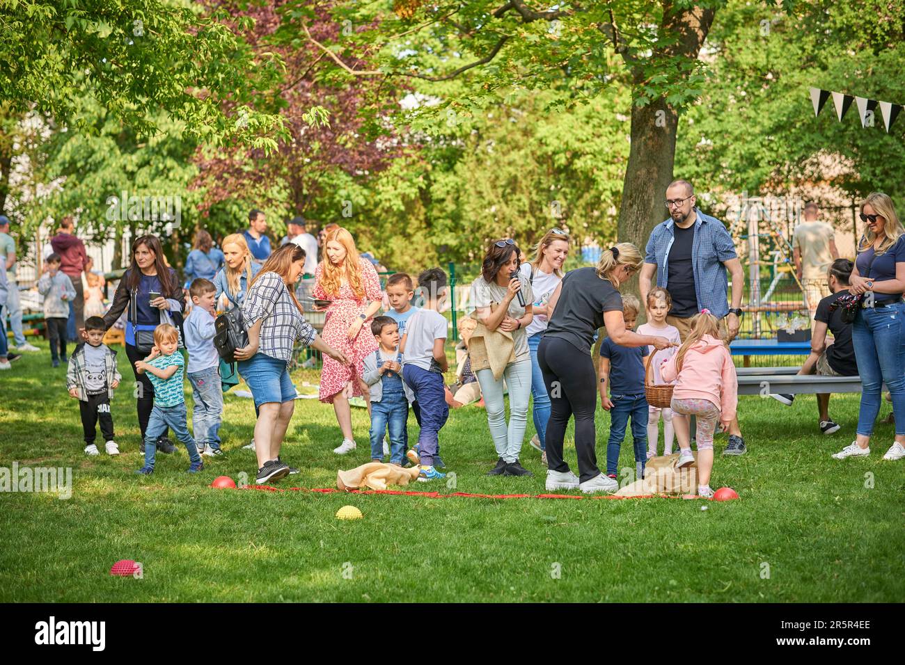 A group of happy children are playing together in the outdoors with ...