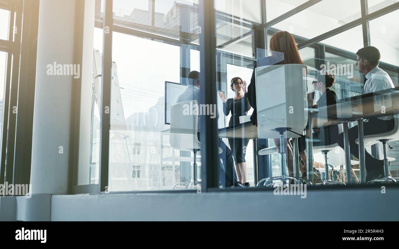 Business by the numbers. an executive giving a presentation on a ...