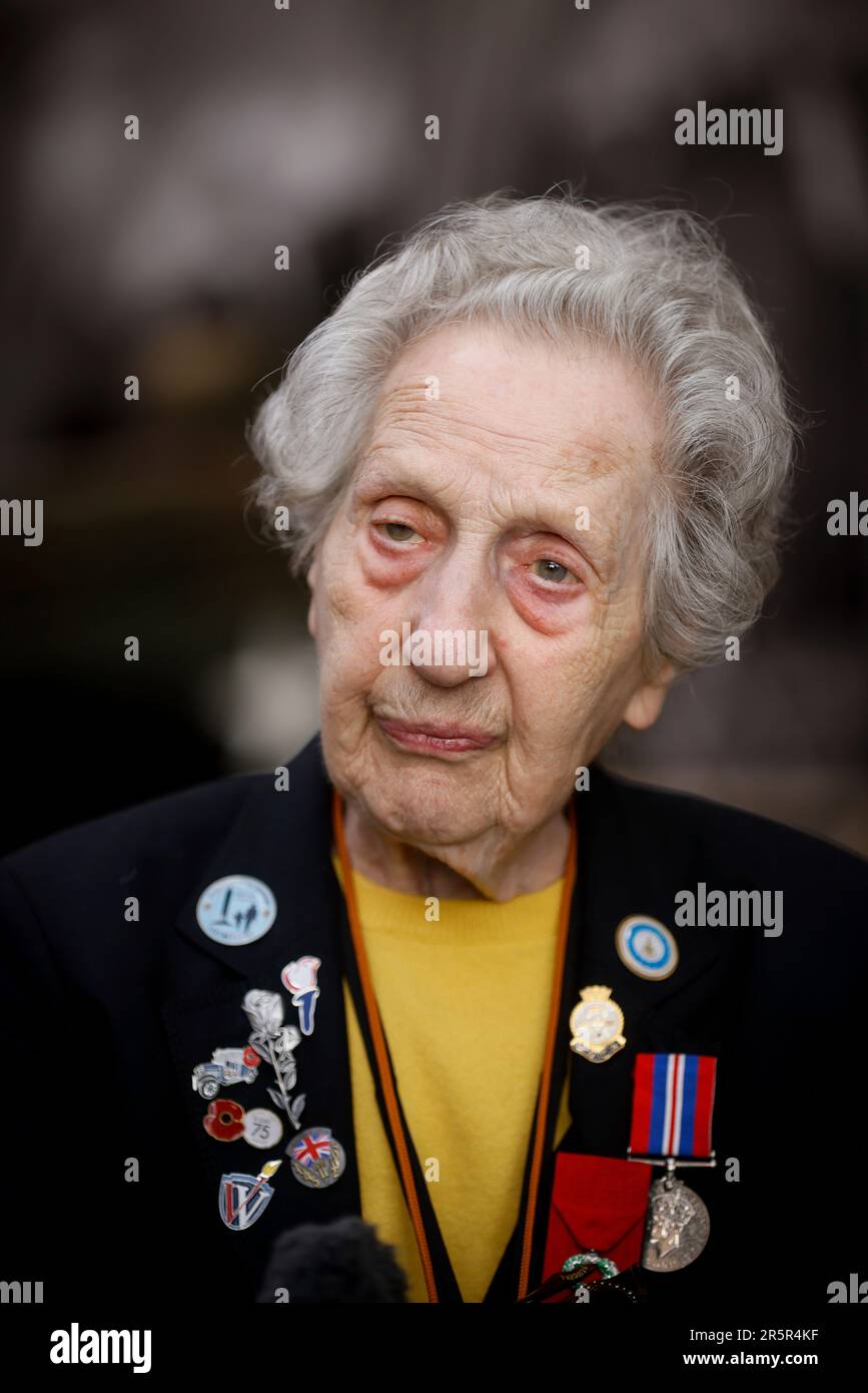 Britain's Marie Scott pushes a World War II attends a ceremony at the ...