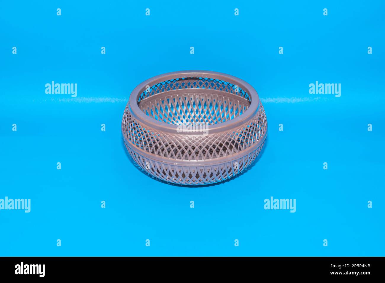 The Versatile Round Plastic Basket in white and brown natural tones is ...