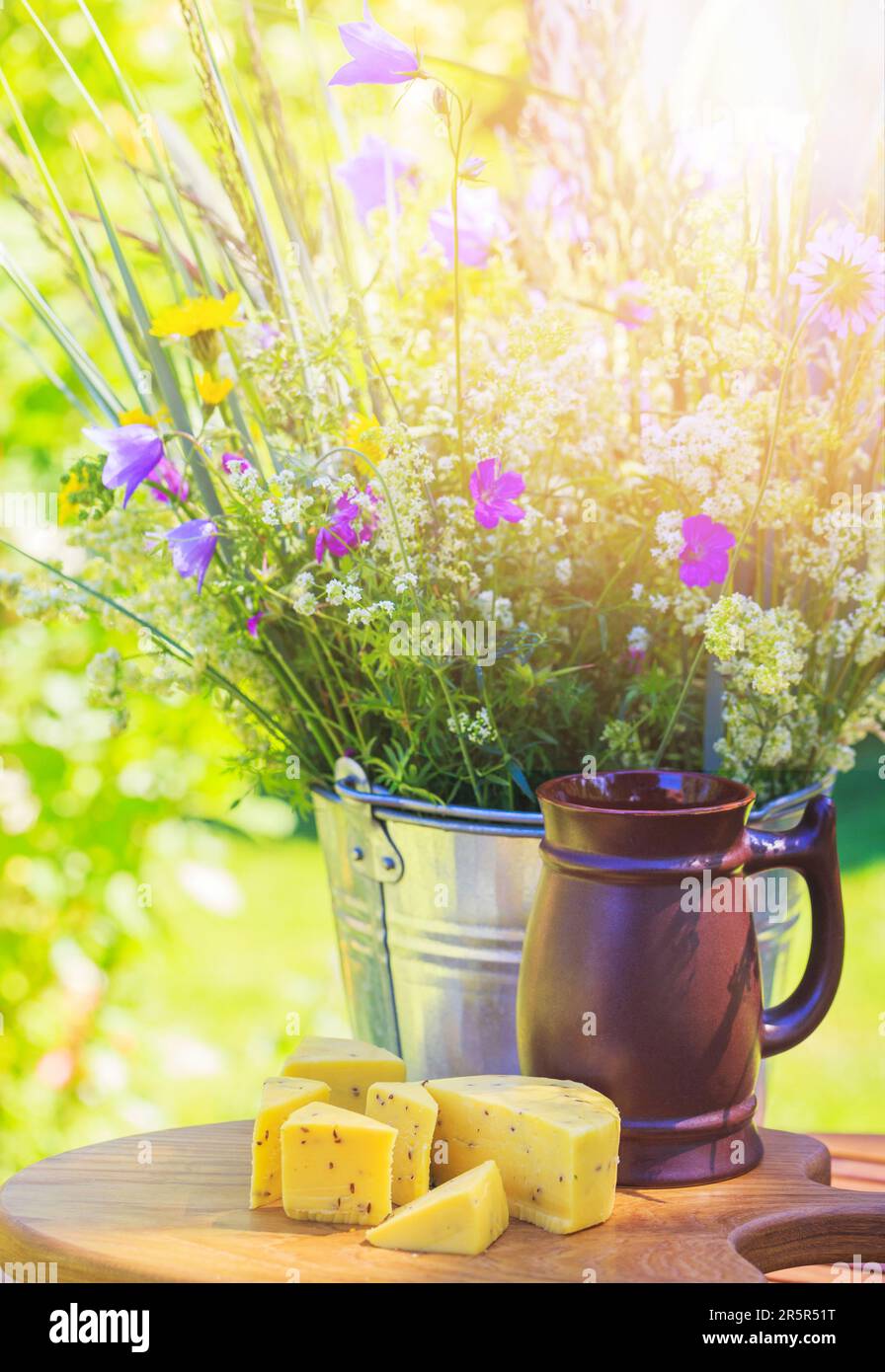 Sliced cheese with cumin on a wooden table. Celebration of a ...