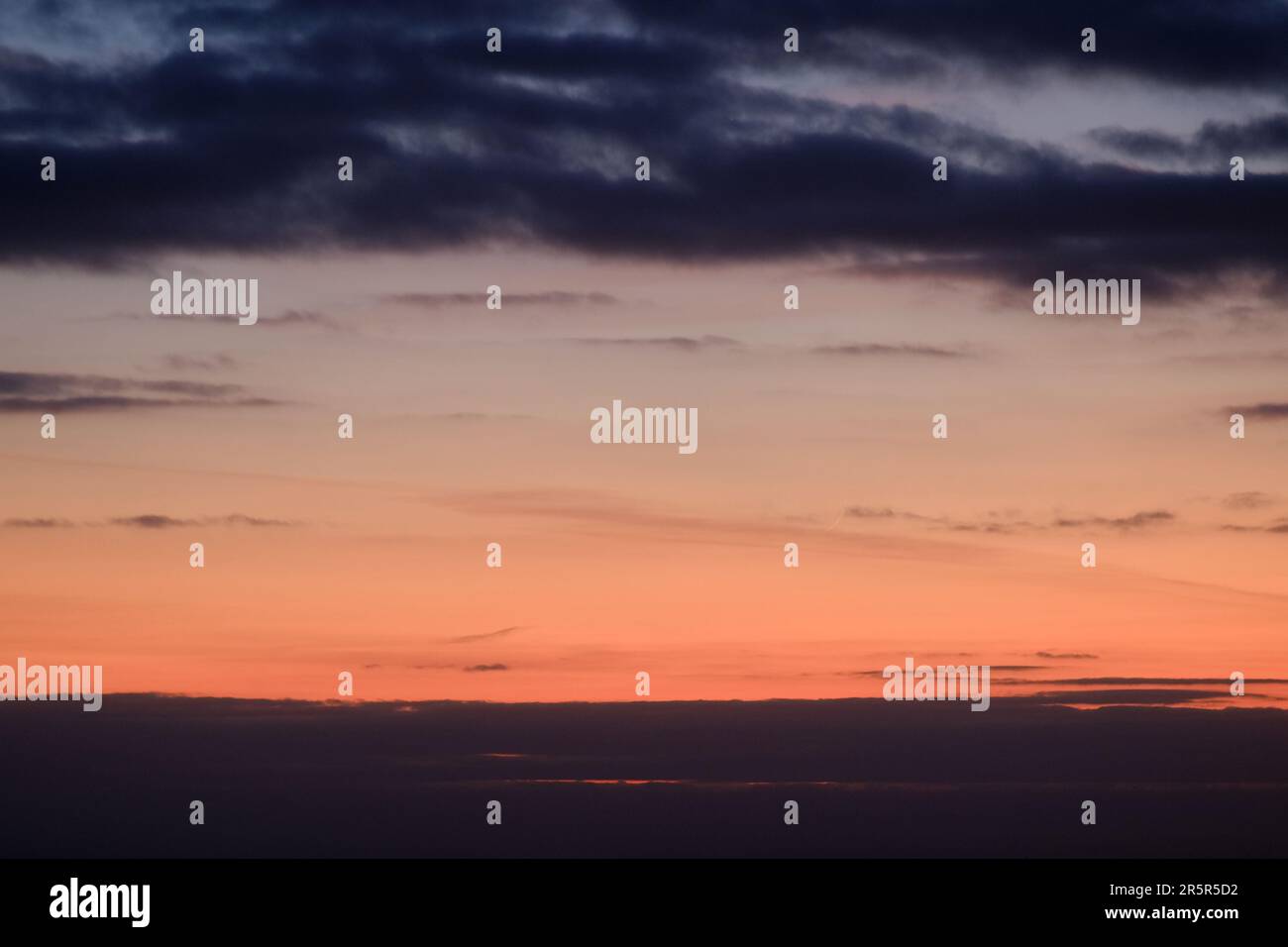 Sunset sky with red light of the setting sun. Evening clouds in the ...