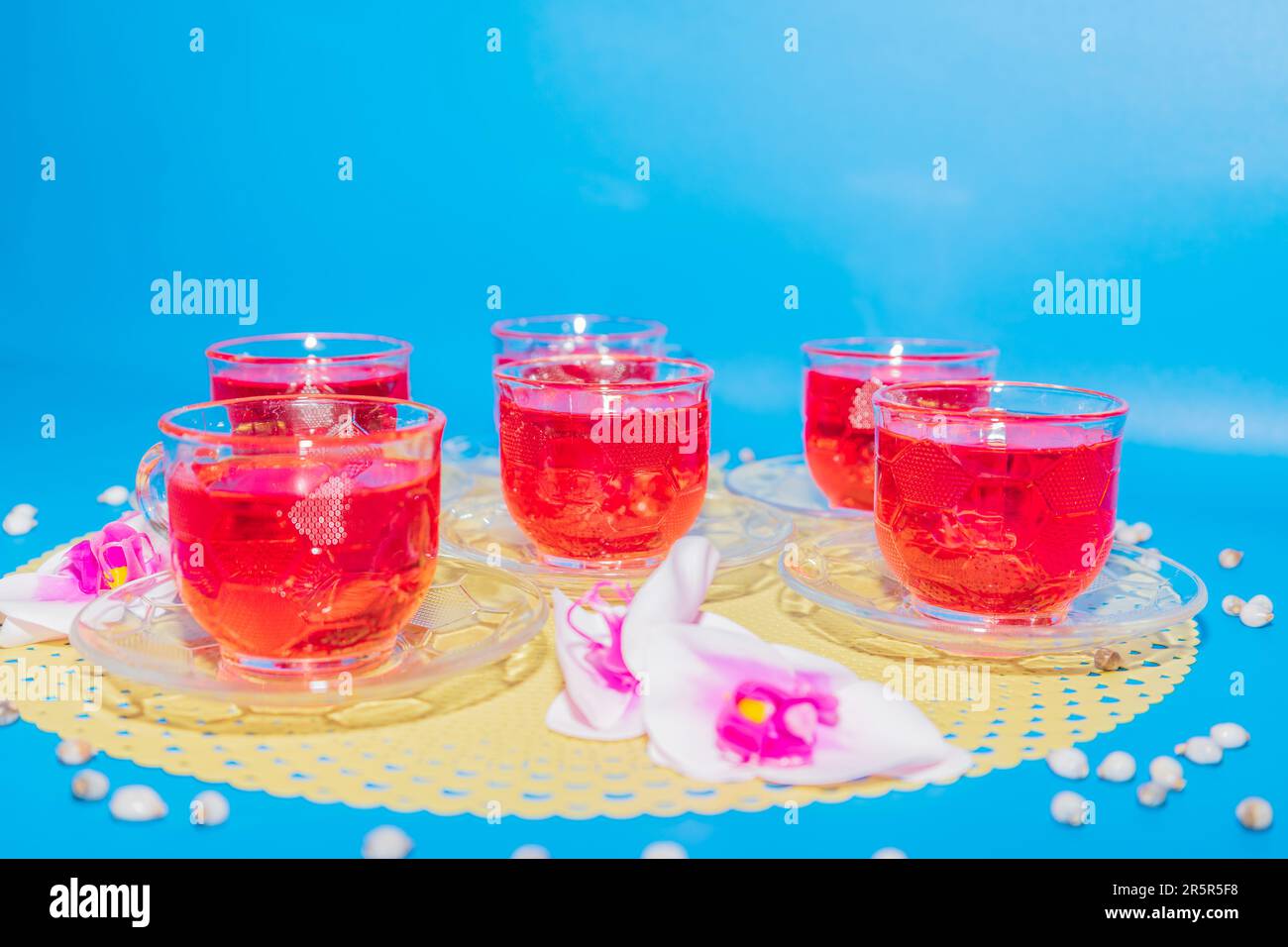 This clear glass cup allows you to appreciate the vibrant red color of ...