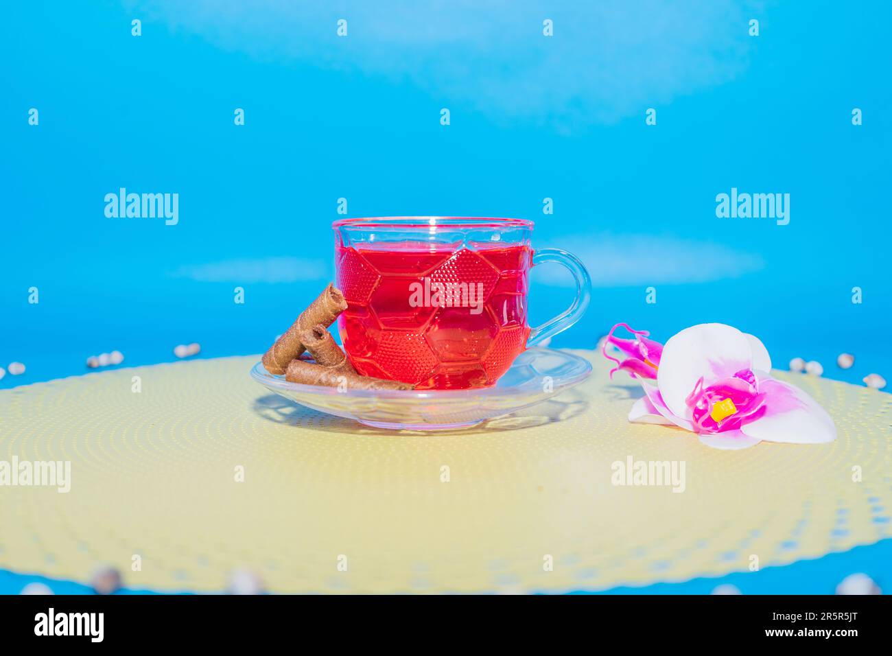 This clear glass cup allows you to appreciate the vibrant red color of ...