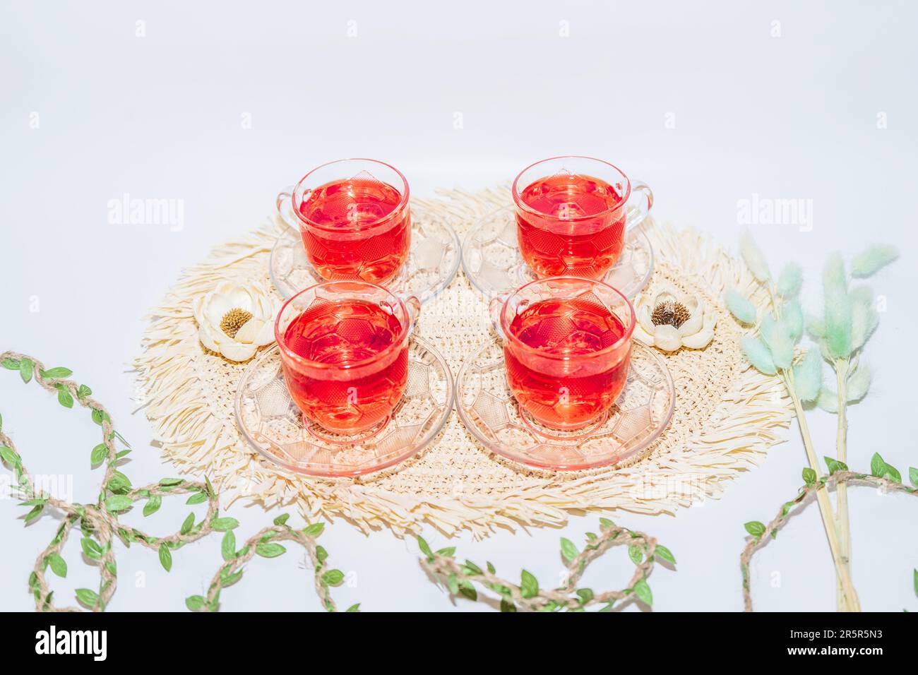 This clear glass cup allows you to appreciate the vibrant red color of ...