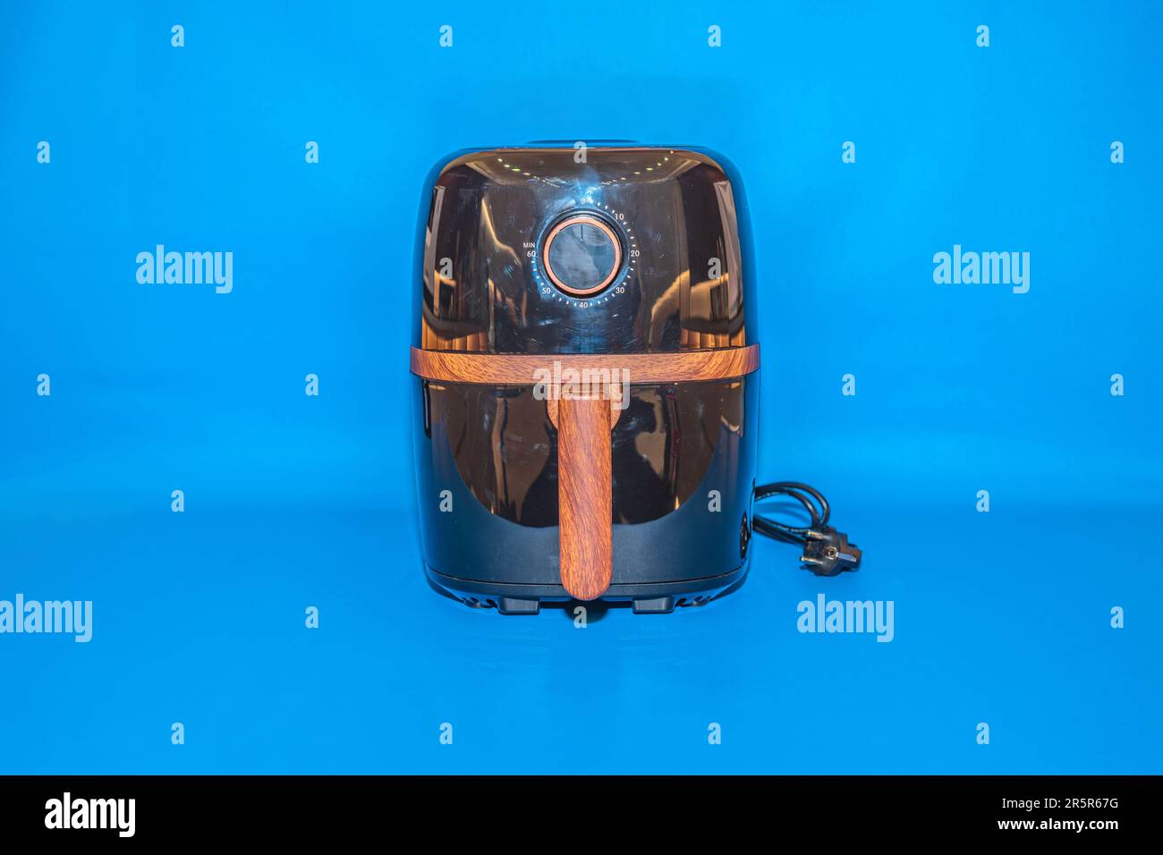 The Black Air Fryer with Wooden Handle Design offers a combination of ...