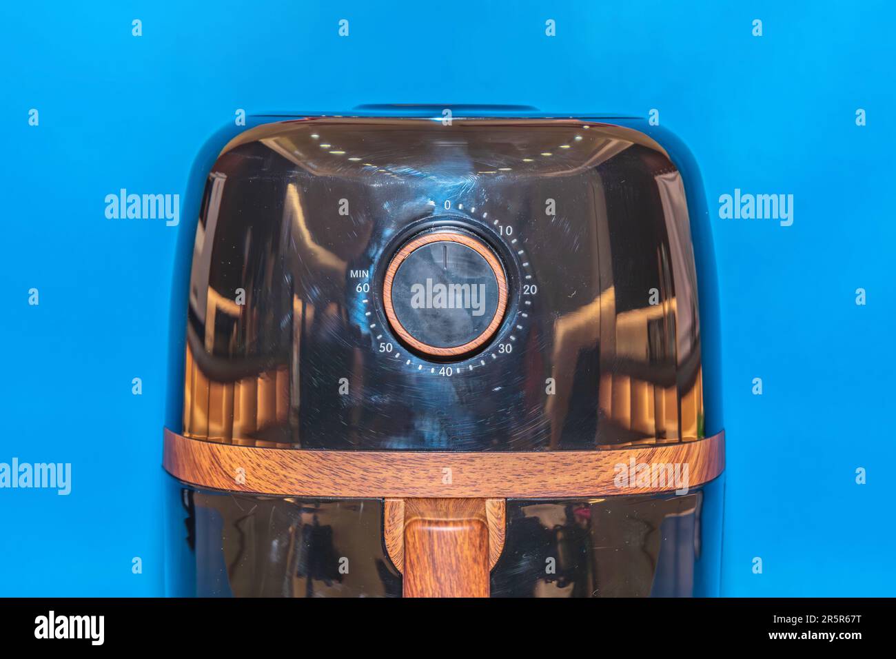 The Black Air Fryer with Wooden Handle Design offers a combination of ...