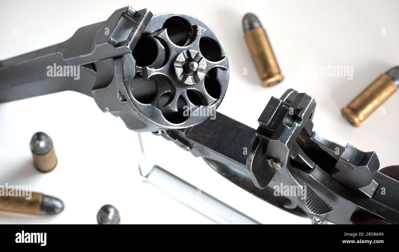 A gun with metal stud detailing and several bullet rounds lying around ...