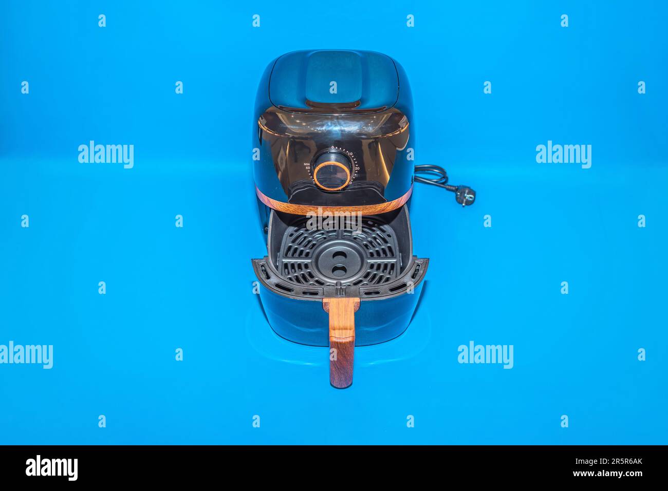 The Black Air Fryer with Wooden Handle Design offers a combination of ...