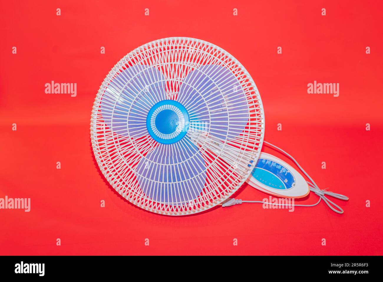 The Blue and White Wall-Mounted Fan is a versatile and practical ...