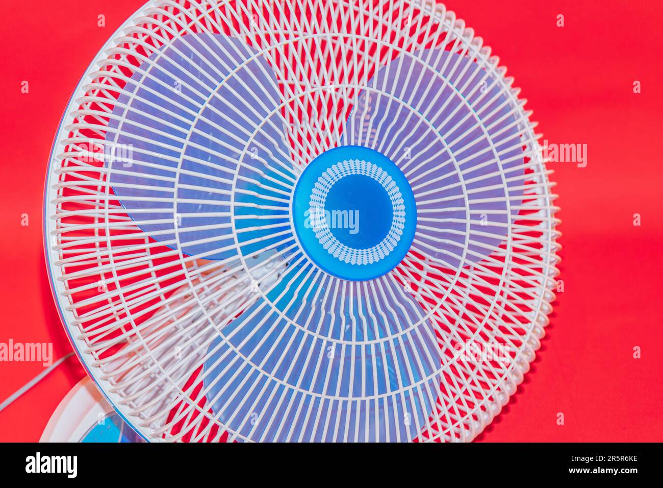 The Blue and White Wall-Mounted Fan is a versatile and practical ...