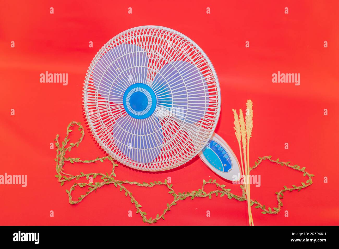 The Blue and White Wall-Mounted Fan is a versatile and practical ...