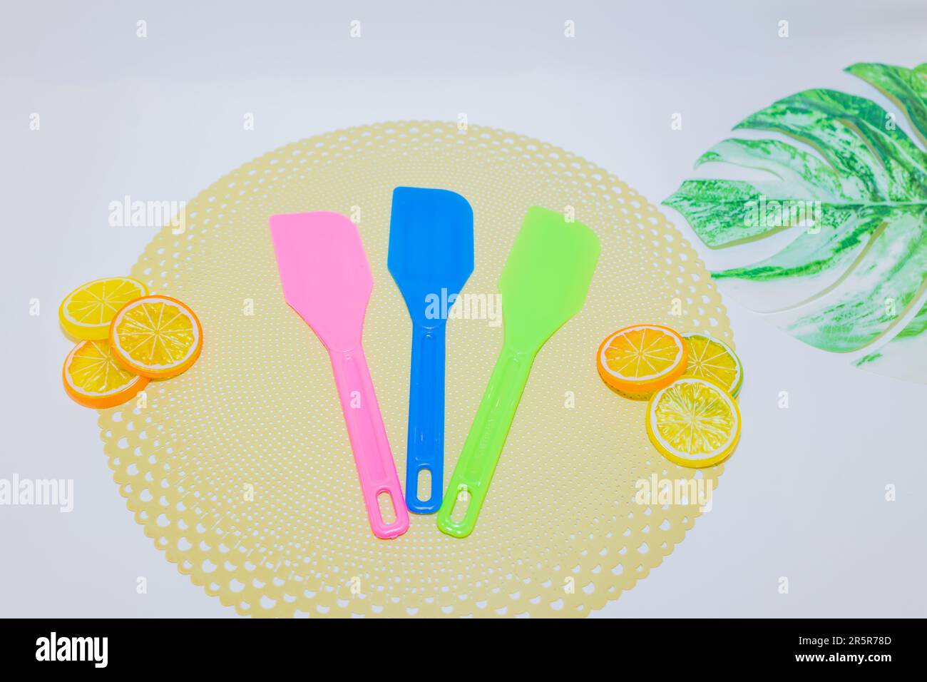 The Colorful Plastic Spatula Set includes spatulas in vibrant shades of ...
