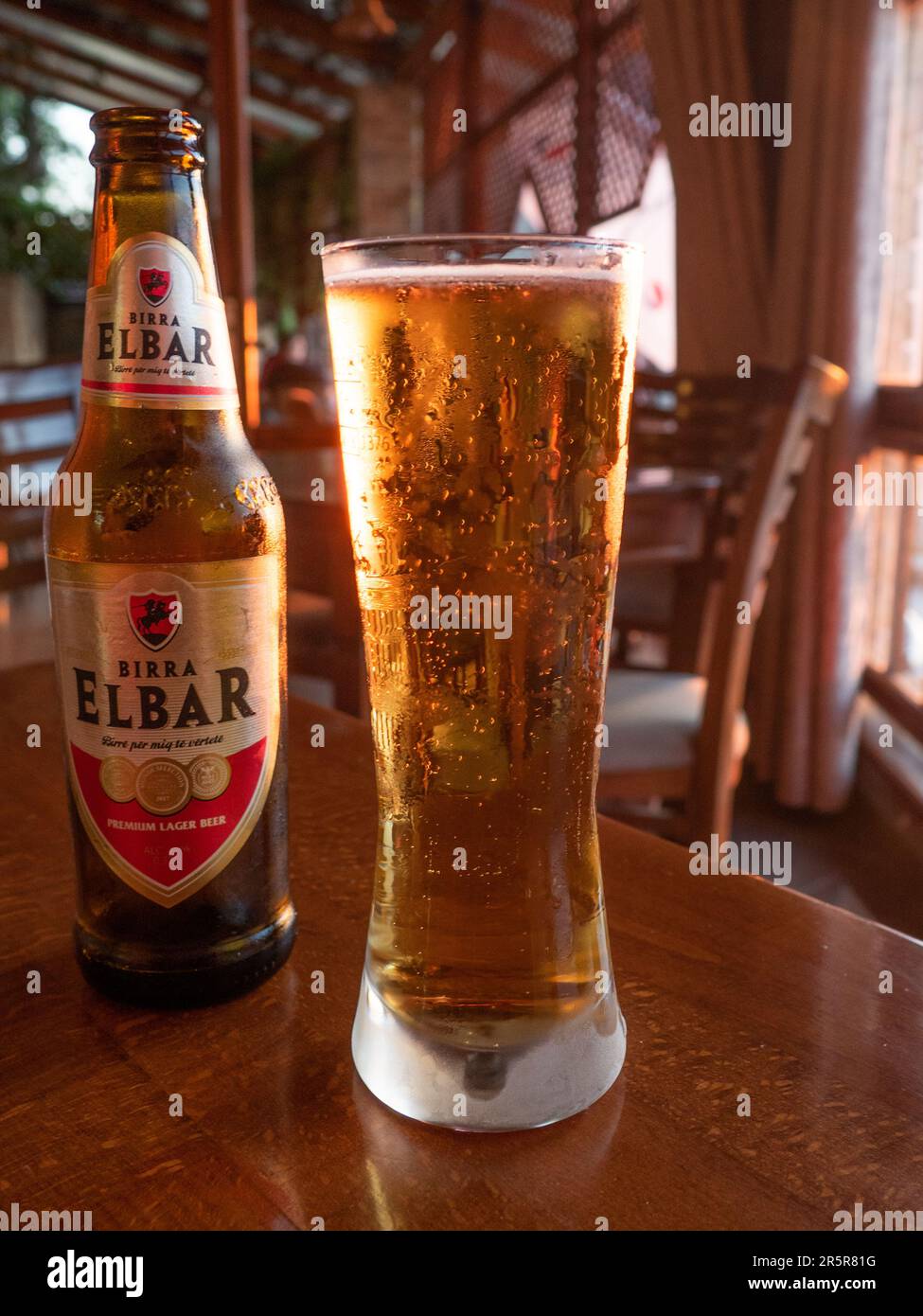 Berat - Albania, September, 3 2021 - Glass and bottle of Elbar beer on ...