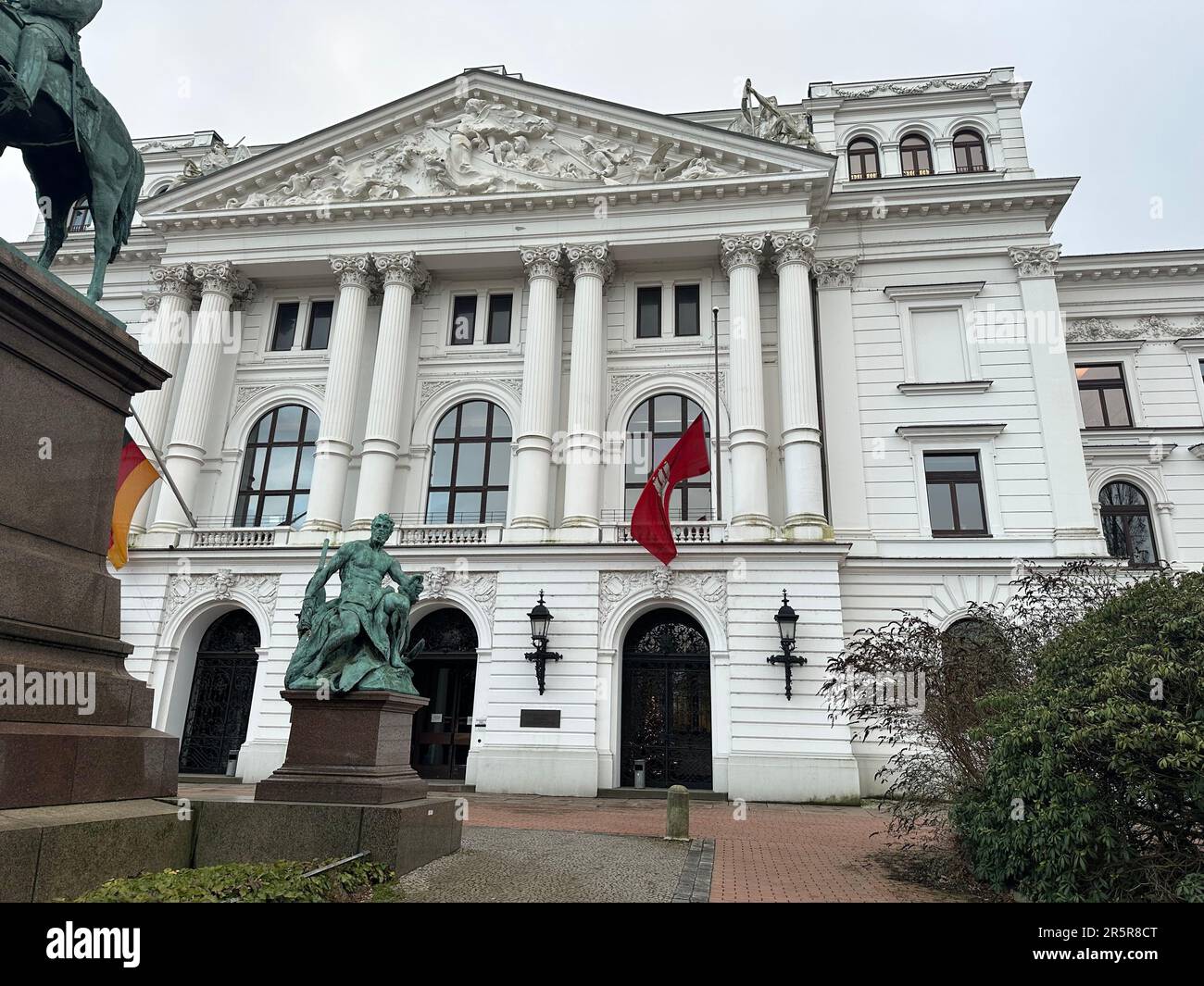 The Altona City Hall surrounded by greenery and statues in Hamburg ...