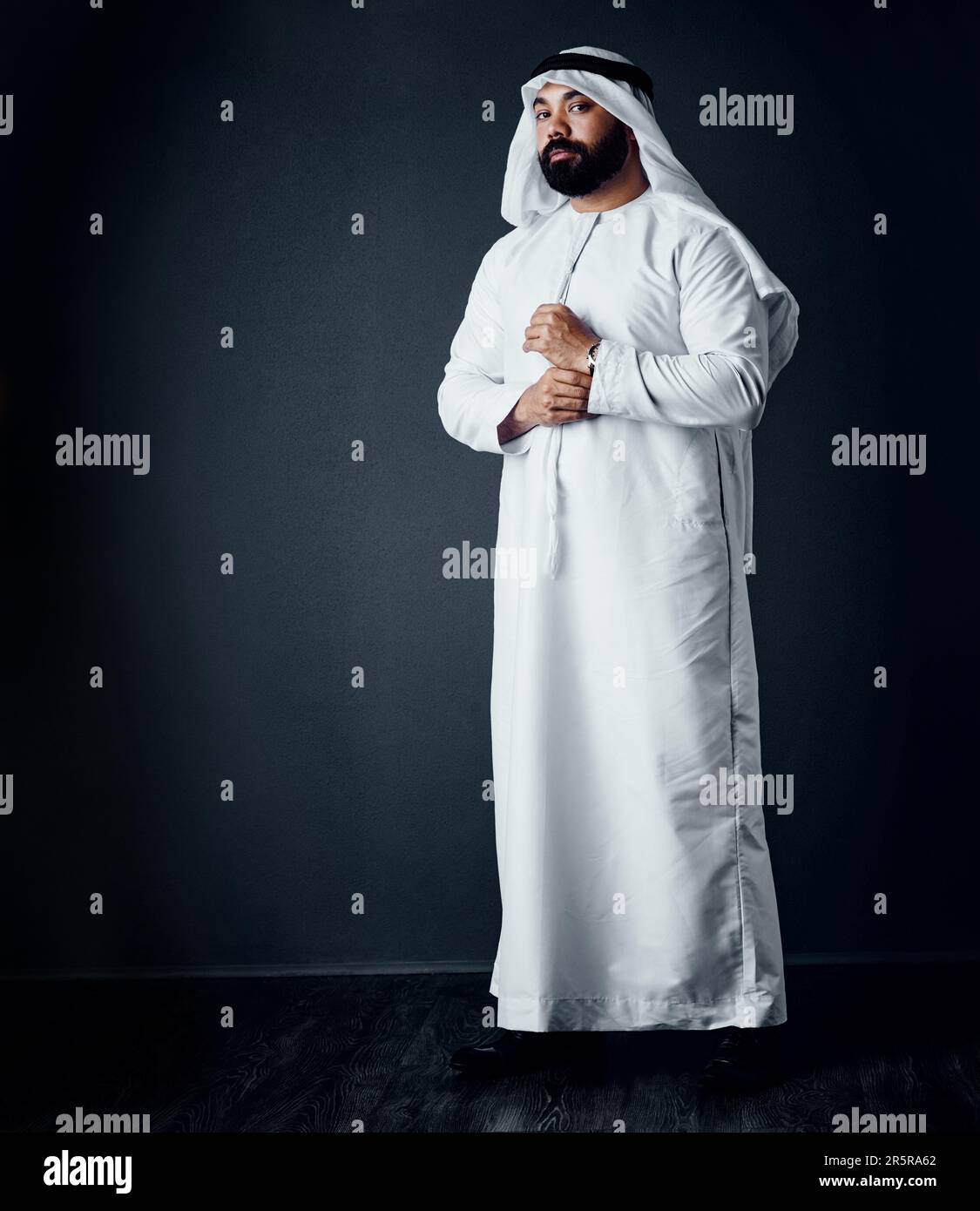 He wears his traditional clothing well. Studio shot of a young man ...
