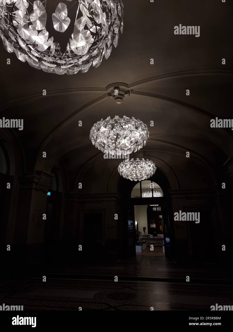 Two clear glass orbs hang suspended in midair between the floor and ...