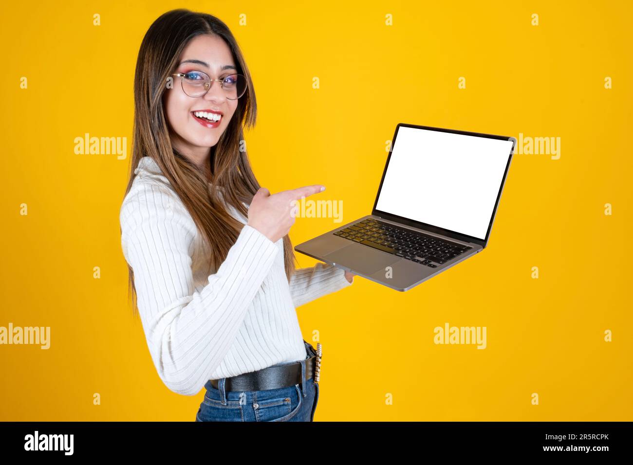 side view portrait of woman pointing laptop screen. Young businesswoman holding notebook, empty ...