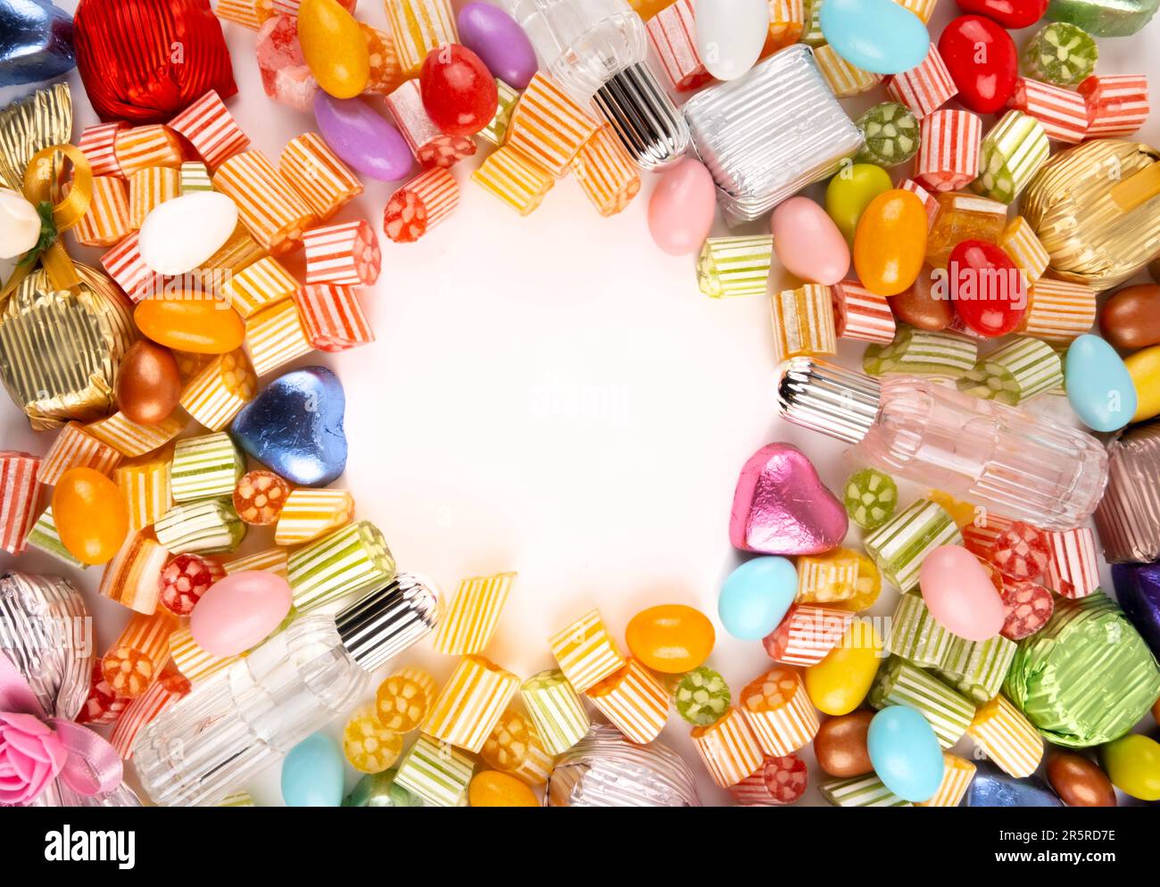 Top view image of mixed candies. Circle white copy space in the middle ...