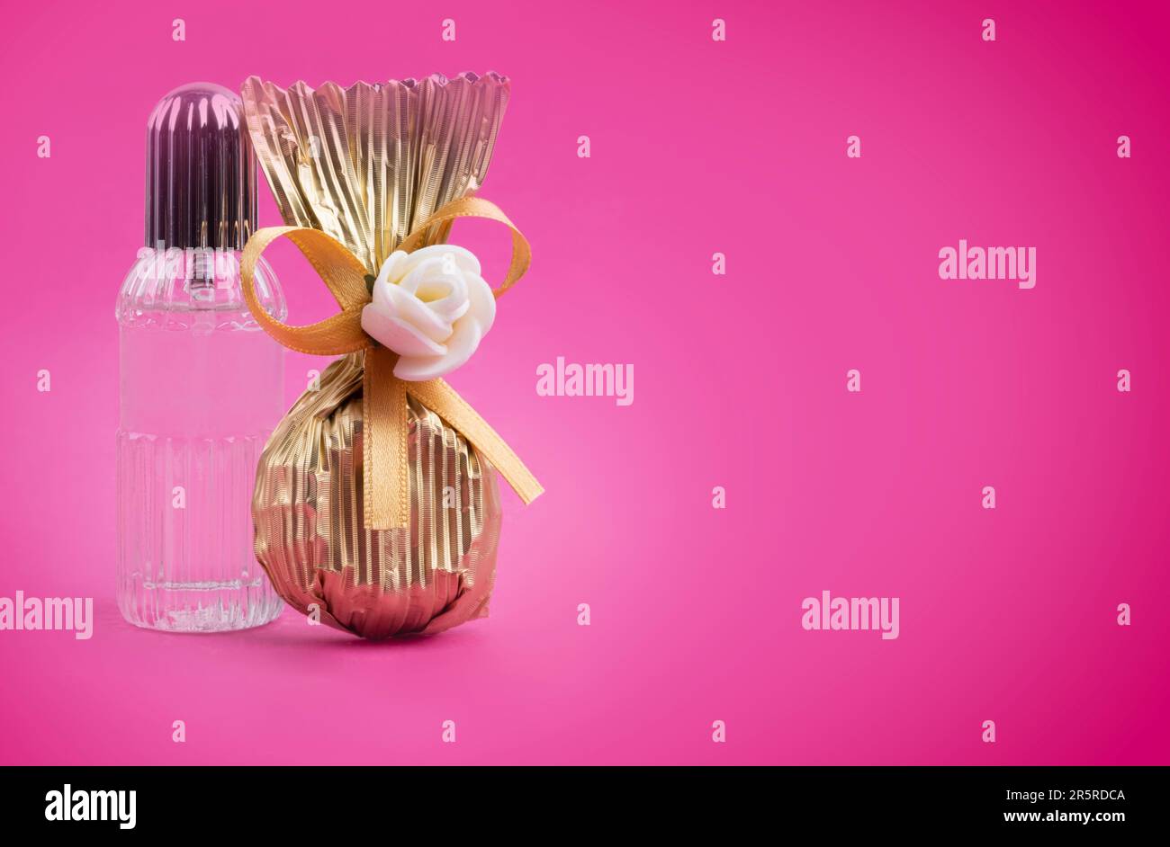 Close up image of luxury packaged chocolate. Little cologne bottle and ...