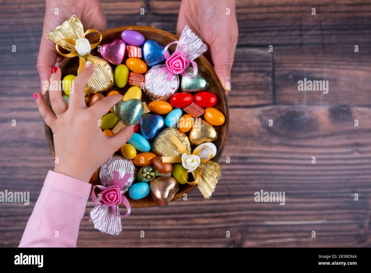 Top view image of woman hand holding serving confectionery. Child girl ...