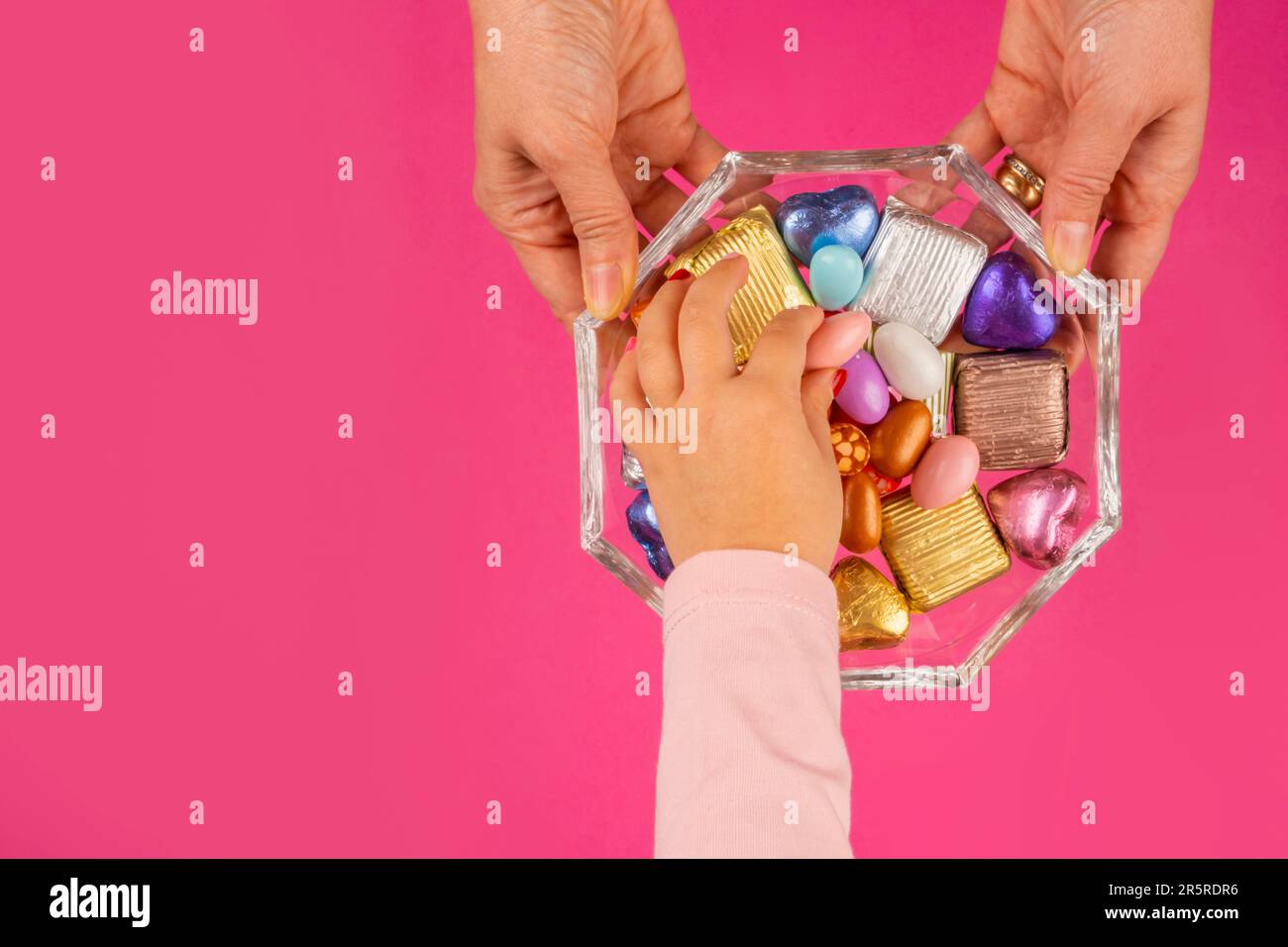 Top view image of sugar feast concept. Woman hands holding glass sweet ...