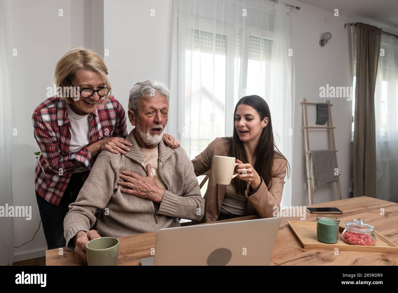 Happy three-generation family hugging sit indoors enjoy time together ...