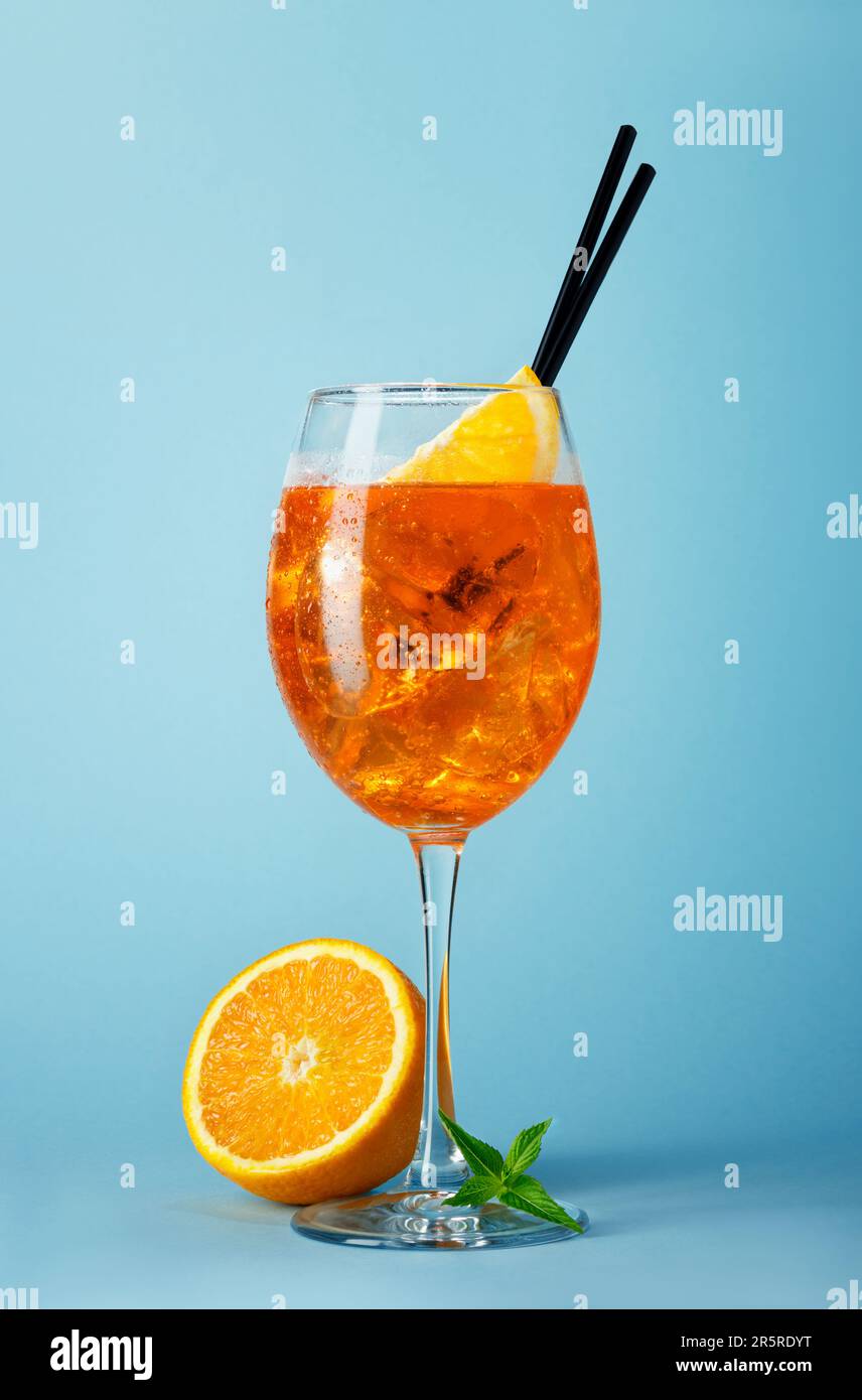 aperol spritz cocktail in glass on blue background Stock Photo - Alamy