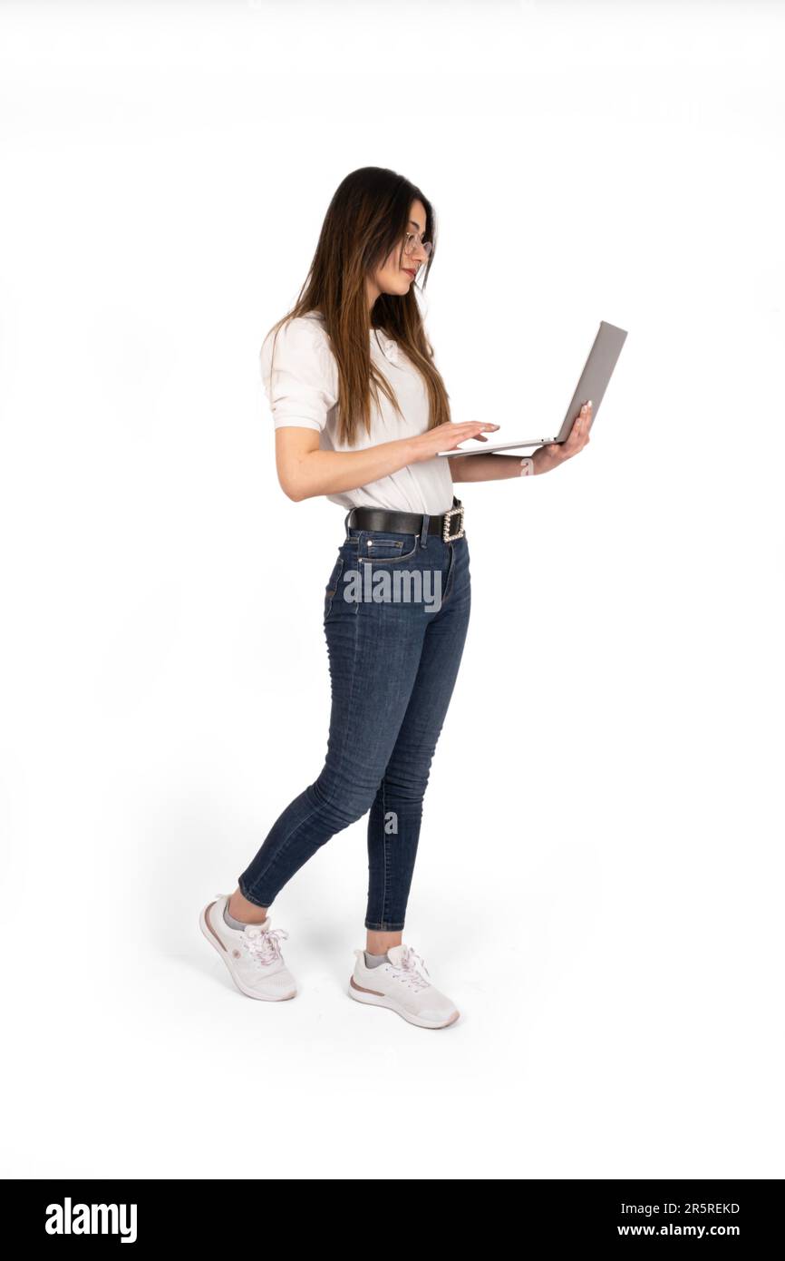 Using laptop, full length body size side view of woman using laptop ...