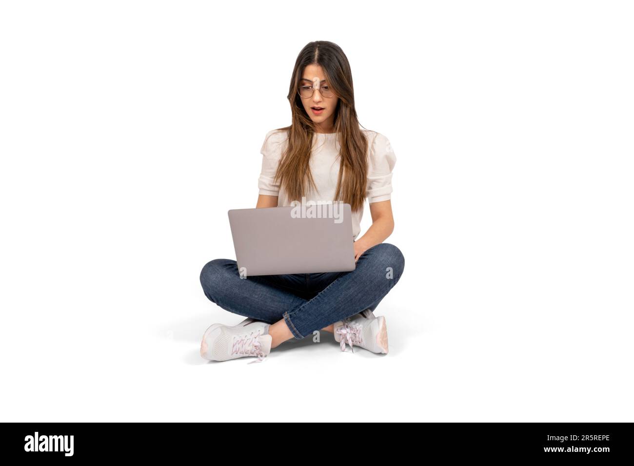 Shocked young woman, full body shot of shocked young woman. Sitting on ...