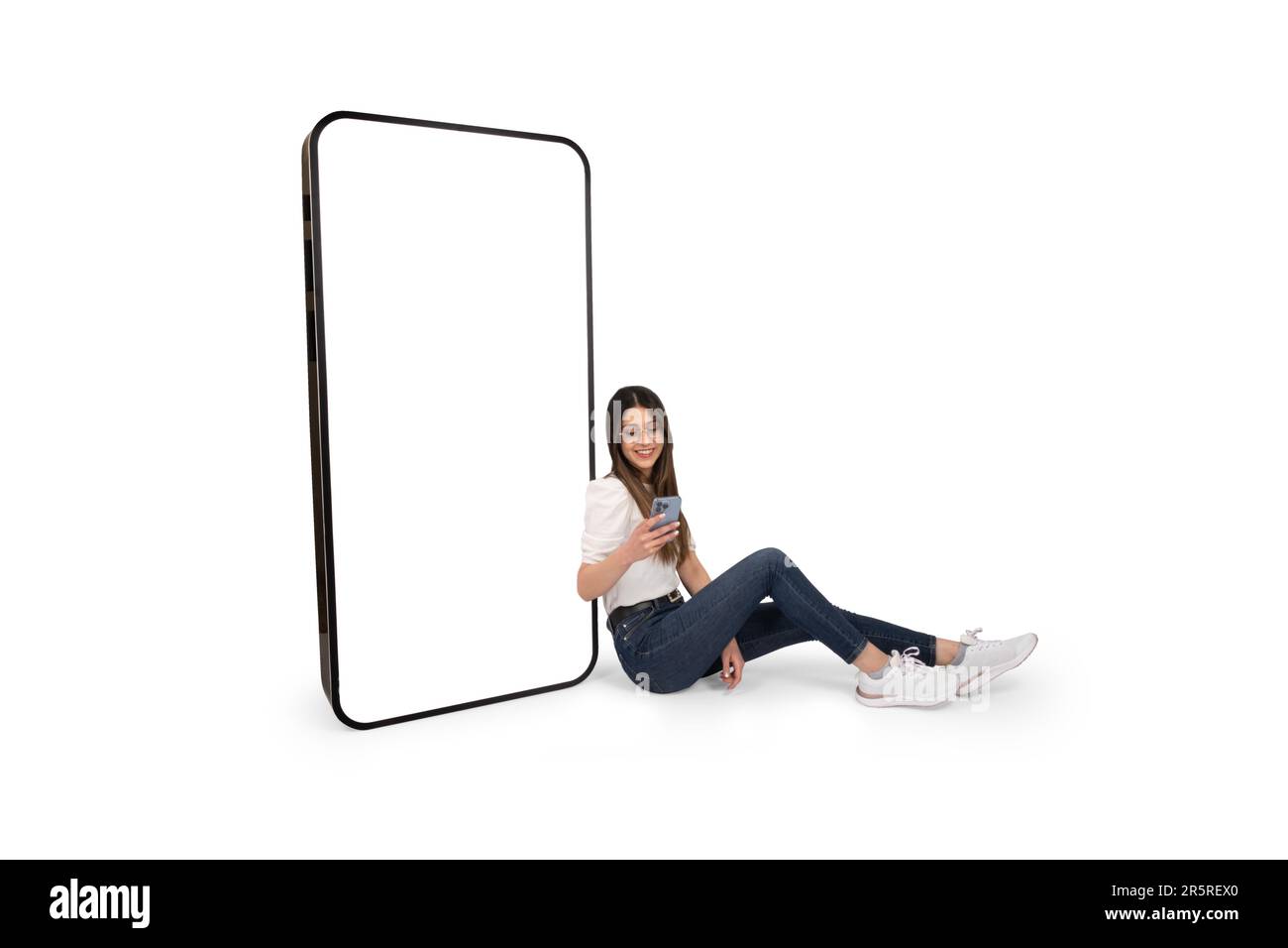 Big mobile phone mock up. Young brunette woman sit floor leaning huge ...