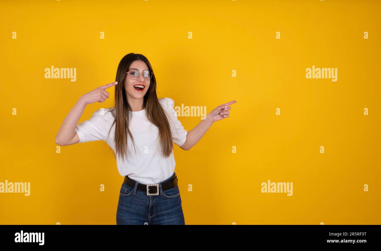 Portrait of excited happy woman pointing fingers aside copy space. Recommend, offer advertising ...