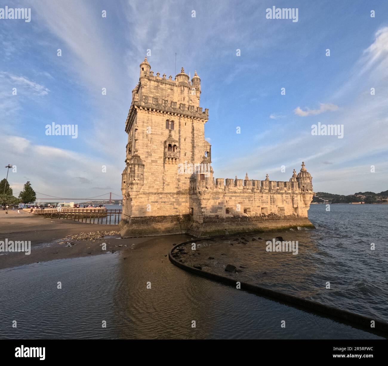 Belem Tower at sunset, its silhouette against a radiant sky. A symbol ...