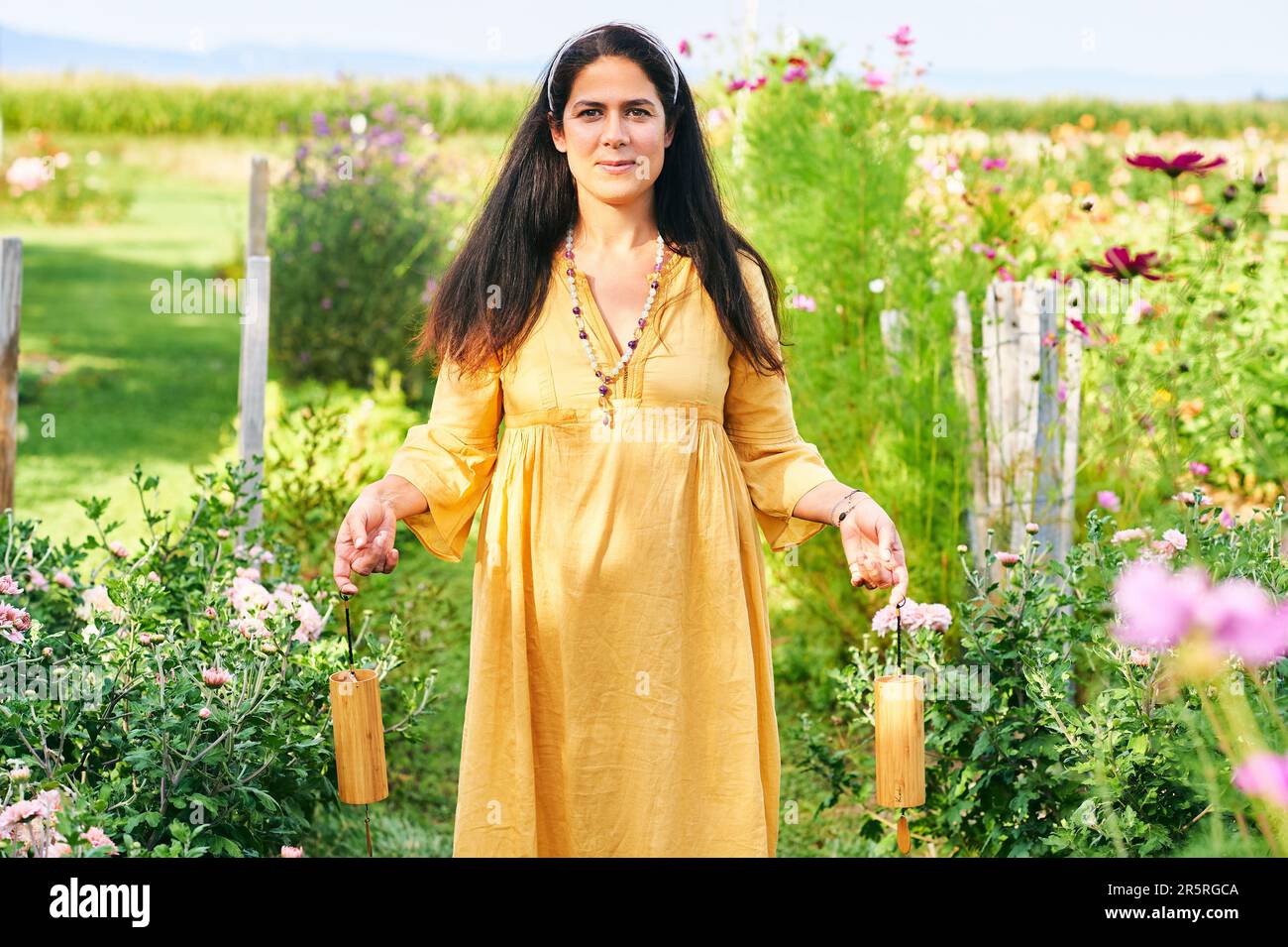 Spiritual woman performing guided meditation through music using koshi ...