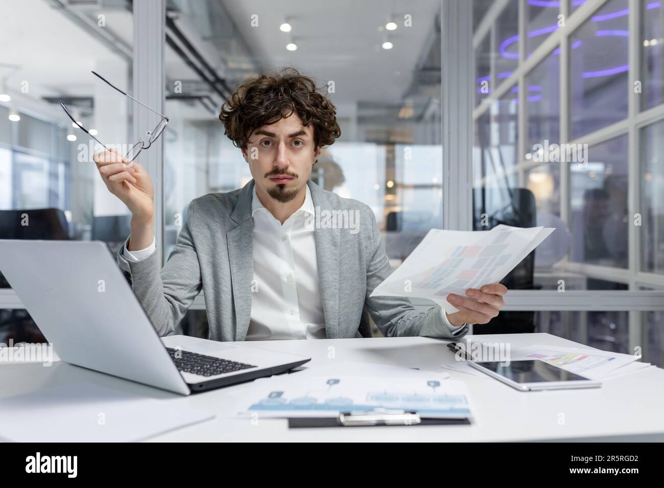 Dissatisfied and angry businessman inside office showing reports and ...