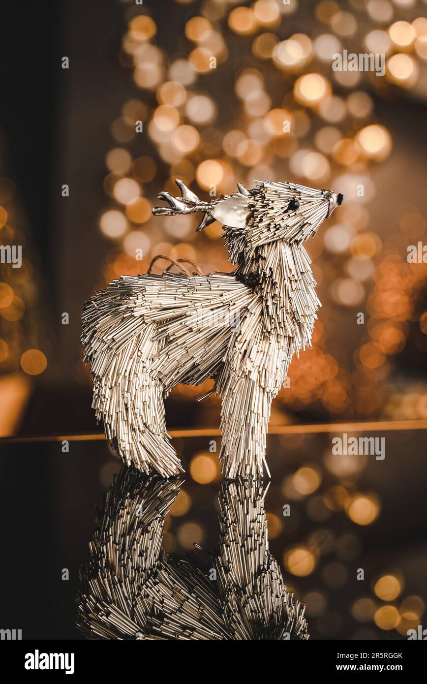 A detailed sculpture of a human figure in a seated position, displayed ...