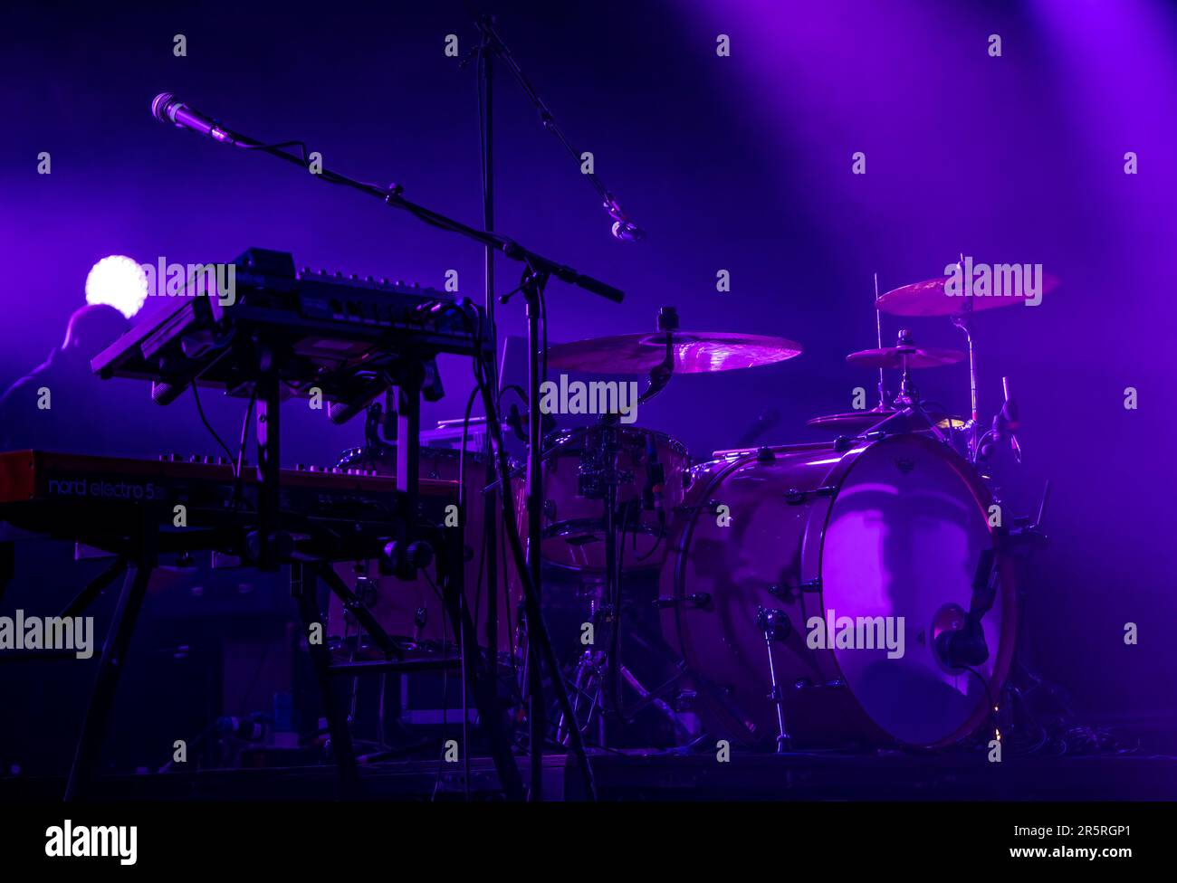 A keyboard and drum kit on stage for a music band to play at a concert ...
