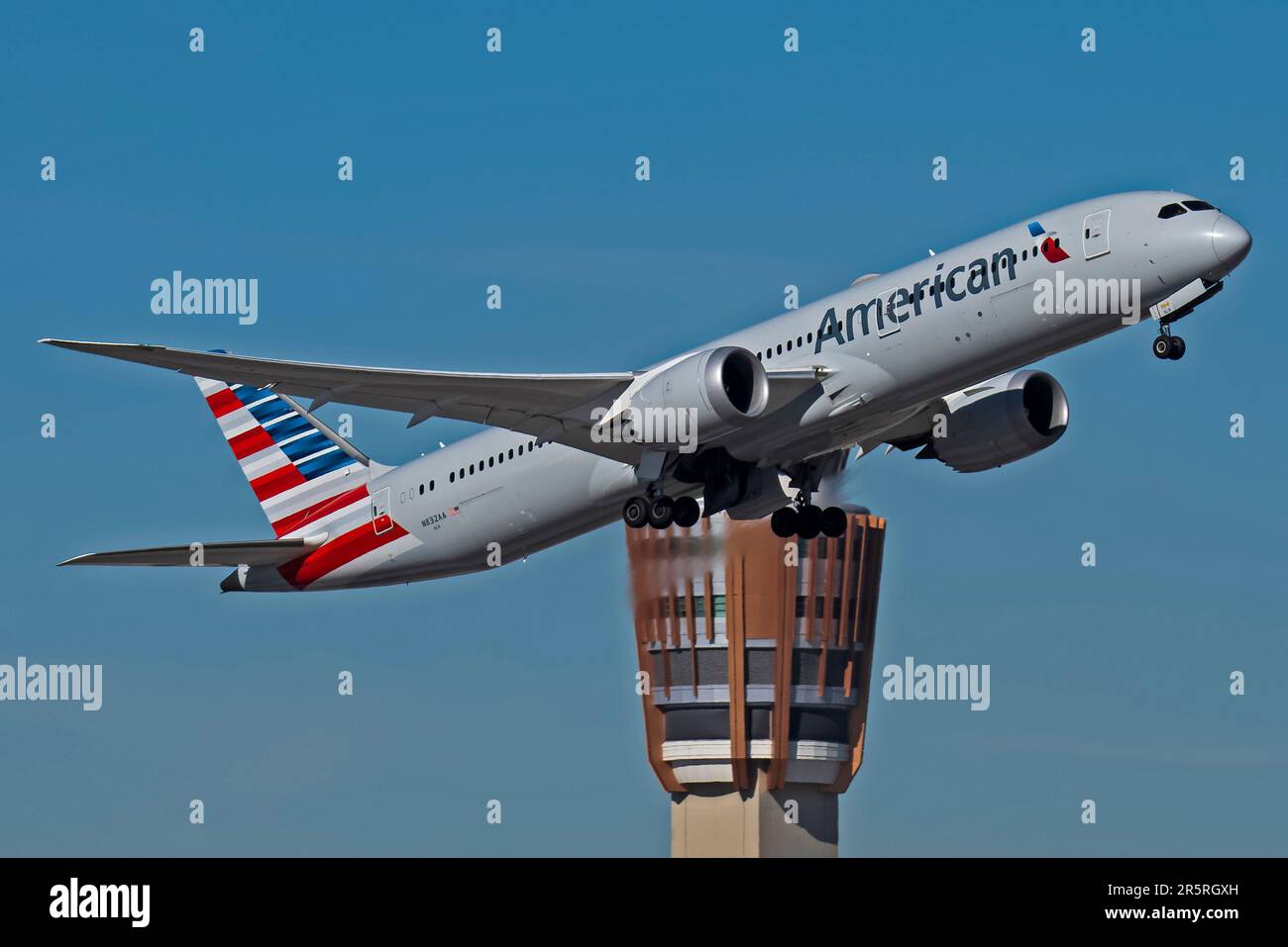 An American Airlines aircraft in the air near a tower in Phoenix, USA ...